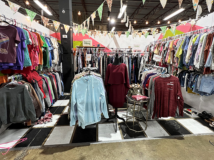 Colorful clothing racks under festive bunting create a perpetual celebration of secondhand style and sustainable fashion choices.