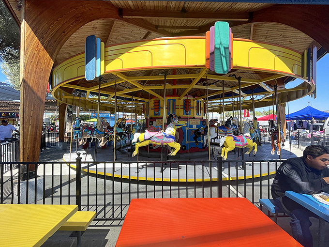 Vintage carousel horses frozen mid-gallop, offering a moment of childhood joy between bargain hunting expeditions. Round and round we go!
