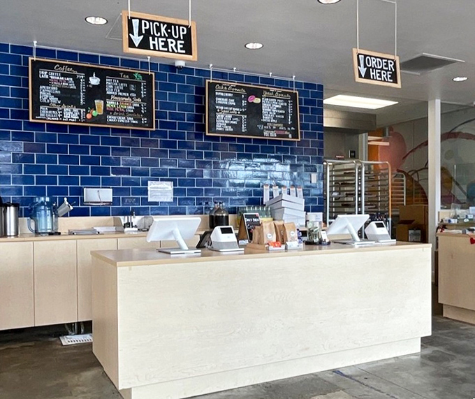 Clean lines, blue tile, and efficient design – the counter where donut dreams come true and coffee wishes are granted.