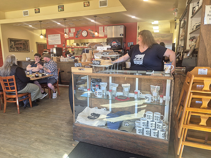 The display case doesn't just hold merchandise&mdash;it holds memories waiting to be made, one Otis Cafe mug at a time.