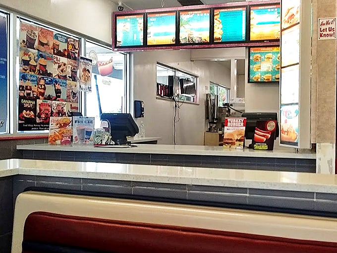 The order counter stands ready for action, with menu boards glowing like a fast-food Broadway marquee announcing today's delicious performances.