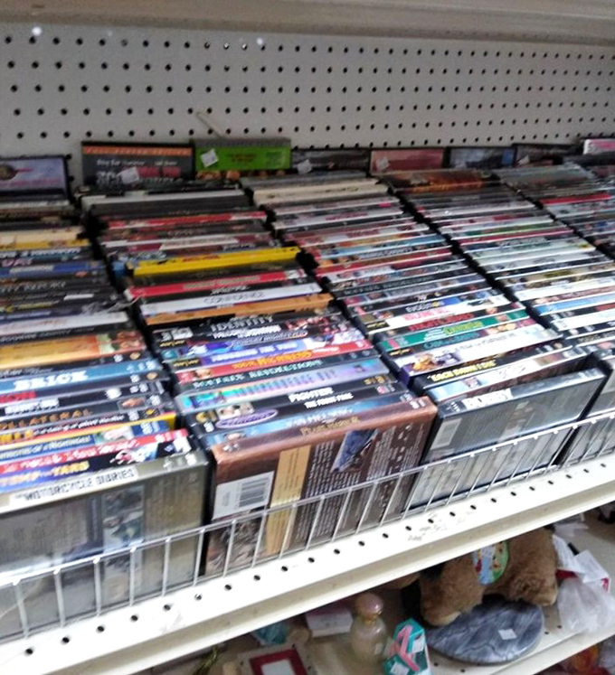 DVDs stacked like a physical Netflix from the pre-streaming era&mdash;a reminder of when "scrolling" meant actually moving your fingers.