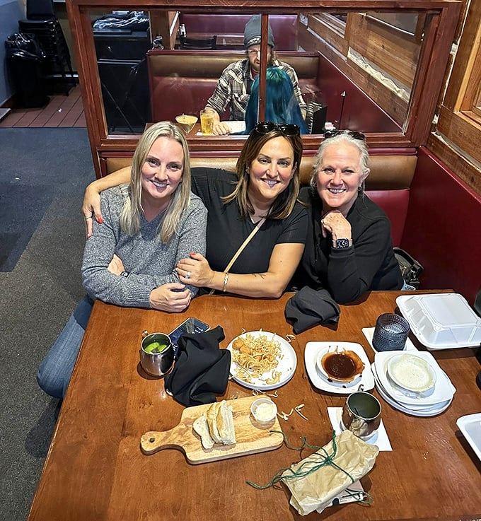 Happy diners creating memories around a wooden table&mdash;the true magic of places like Hickory House isn't just the food, but the connections made over it.