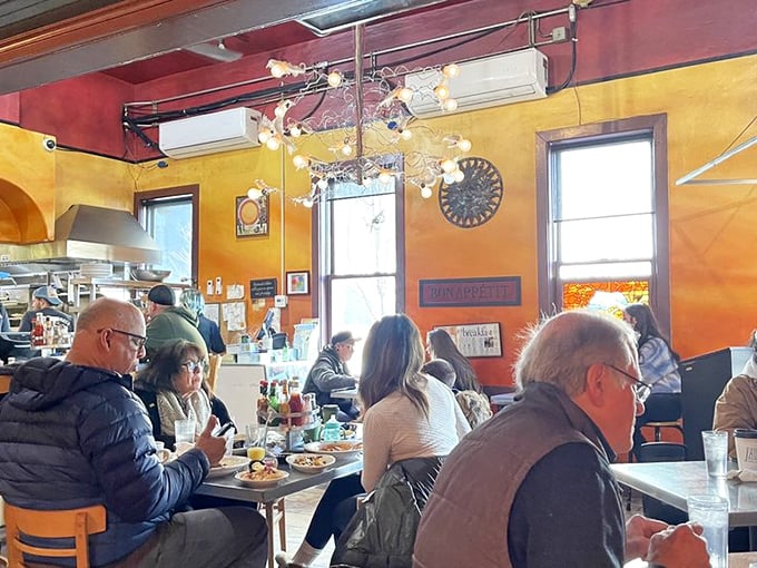 Morning light streams through windows as diners dive into their breakfast treasures. The warm colors match the warm conversations.