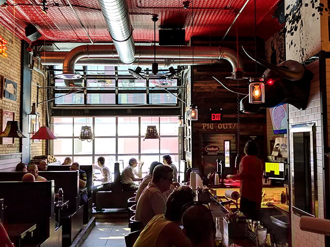 Where barbecue dreams come true: sunlight streams through garage-style windows while patrons engage in the serious business of meat appreciation.