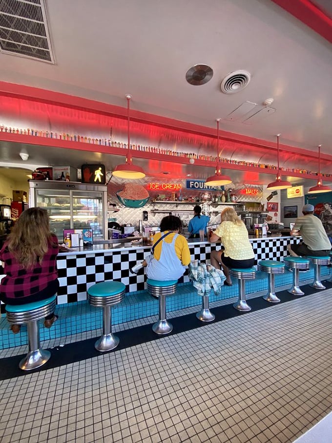 The counter seating offers front-row tickets to the culinary show, with chrome stools that have supported decades of satisfied customers.