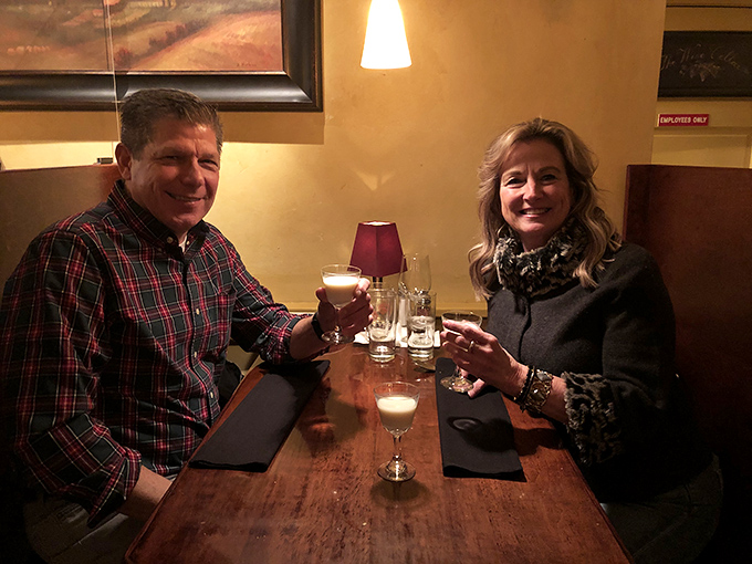 Two people enjoying what appears to be the universal language of good food and drink&mdash;no translation necessary.