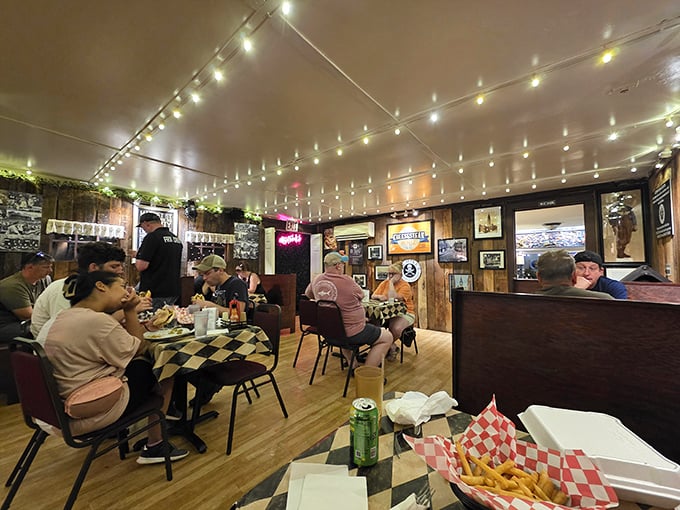 Fellowship of the sandwich: Diners united in the universal language of "mmm" under twinkling lights and surrounded by wood-paneled warmth.