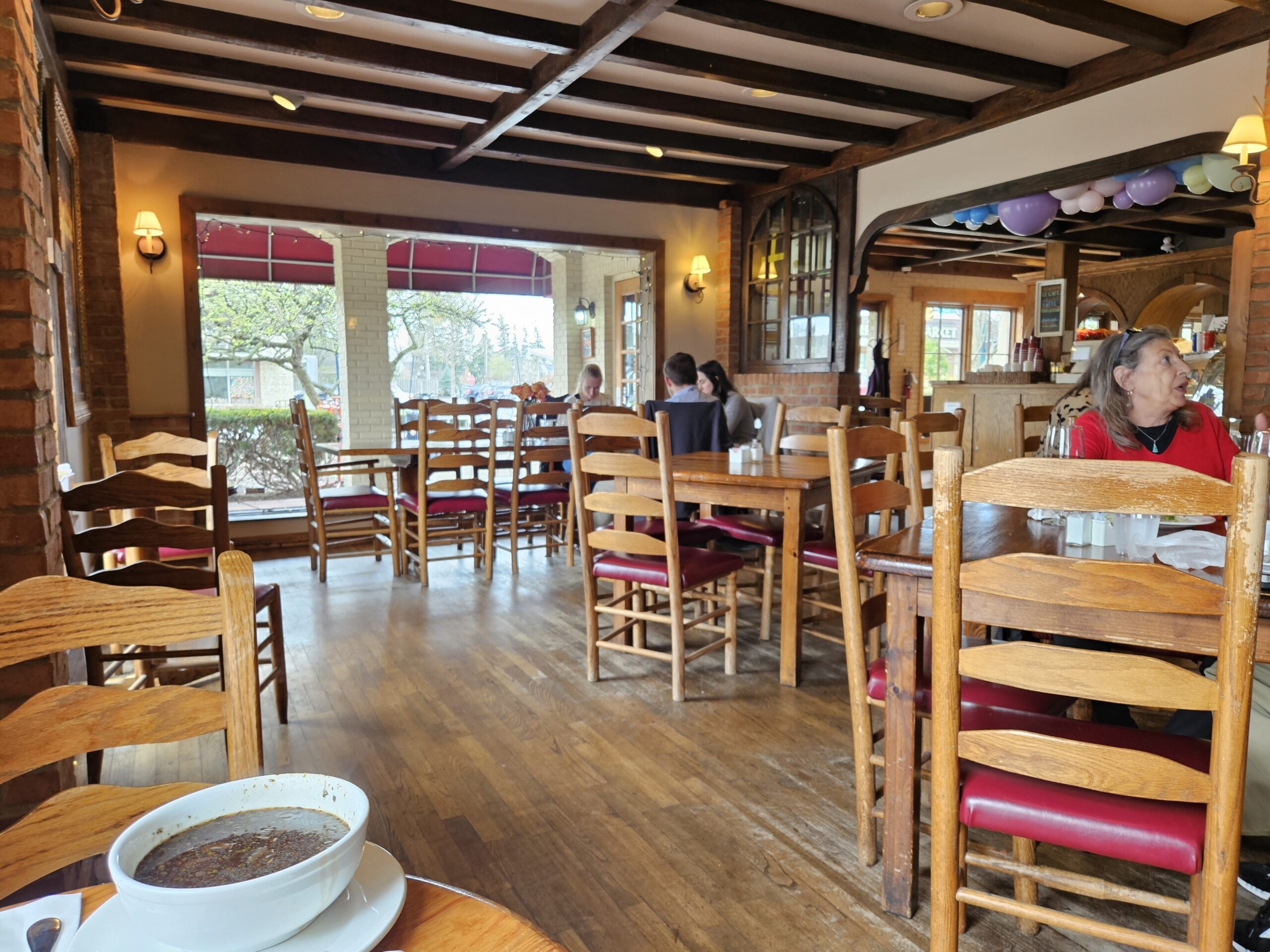 Wooden chairs, brick walls, and warm lighting create the kind of dining room where you'll want to linger long after your plate is clean.