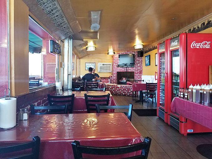 The dining area is simple but inviting, with those brick accents and red tablecloths creating the perfect setting for serious meat consumption.