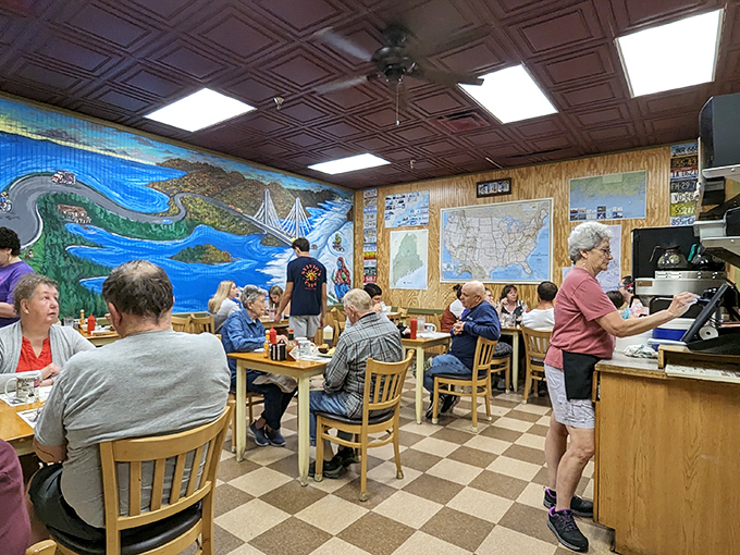 Another angle reveals the dining room's easy camaraderie. Highway signs and Maine memorabilia create an atmosphere where strangers become temporary neighbors over eggs and coffee.