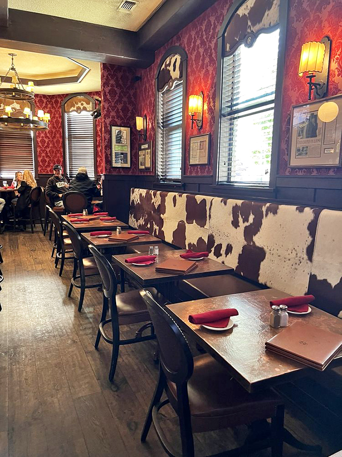 Cowhide booth seating against rich red walls&mdash;this dining area doesn't just serve Western cuisine, it immerses you in it.