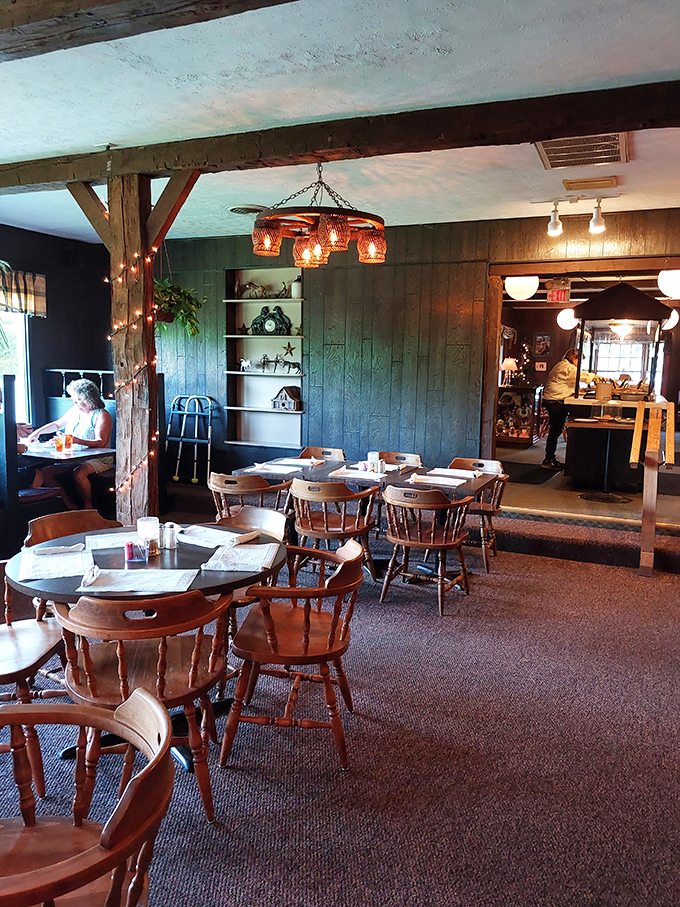 Wooden captain's chairs and exposed beams create a dining room that feels like a warm hug from your favorite aunt's country home.