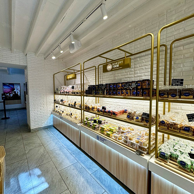 Gold-framed display cases showcase pastries and treats with the reverence of museum pieces, except these masterpieces are meant to be devoured.