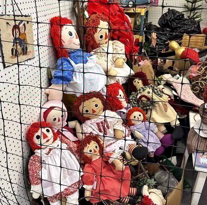 The Raggedy Ann army stands guard in their wire enclosure, red-haired sentinels of simpler times when dolls didn't need batteries or WiFi.
