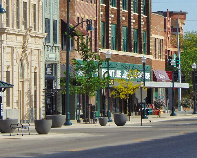 Summer brings Broadway Avenue to life with warm brick, green trees, and the kind of sidewalks made for actual strolling.