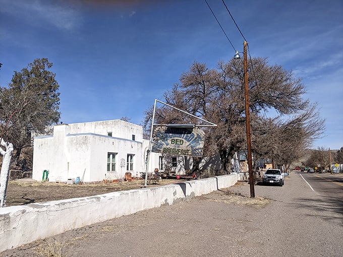 The Enchanted Villa B&B sign swings gently in the breeze, promising the rarest luxury of all: uninterrupted peace and quiet.