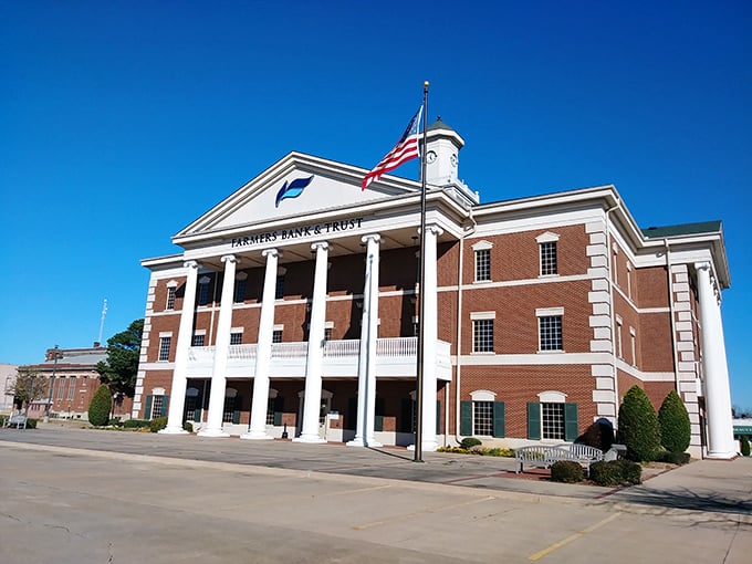 Farmers Bank & Trust stands like a Greek temple dedicated to the deity of fiscal responsibility. Columns never looked so reassuring.