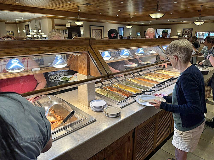 The buffet line&mdash;where dreams are made and diets go to die. Each steaming tray promises comfort that no kale smoothie could ever provide.