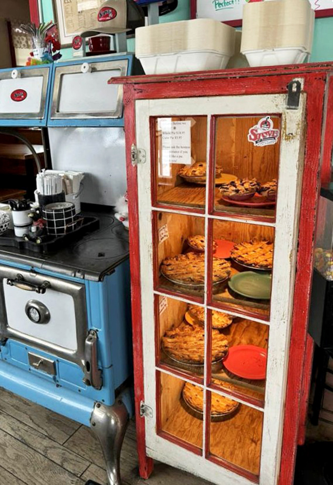 The pie display case—where breakfast intentions go to die and "I'll just have coffee" turns into "and a slice of that, please."