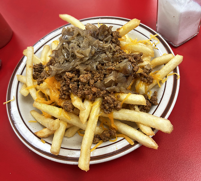 These loaded fries aren't just a side dish—they're a main event where cheese, meat, and onions throw the party of the century.