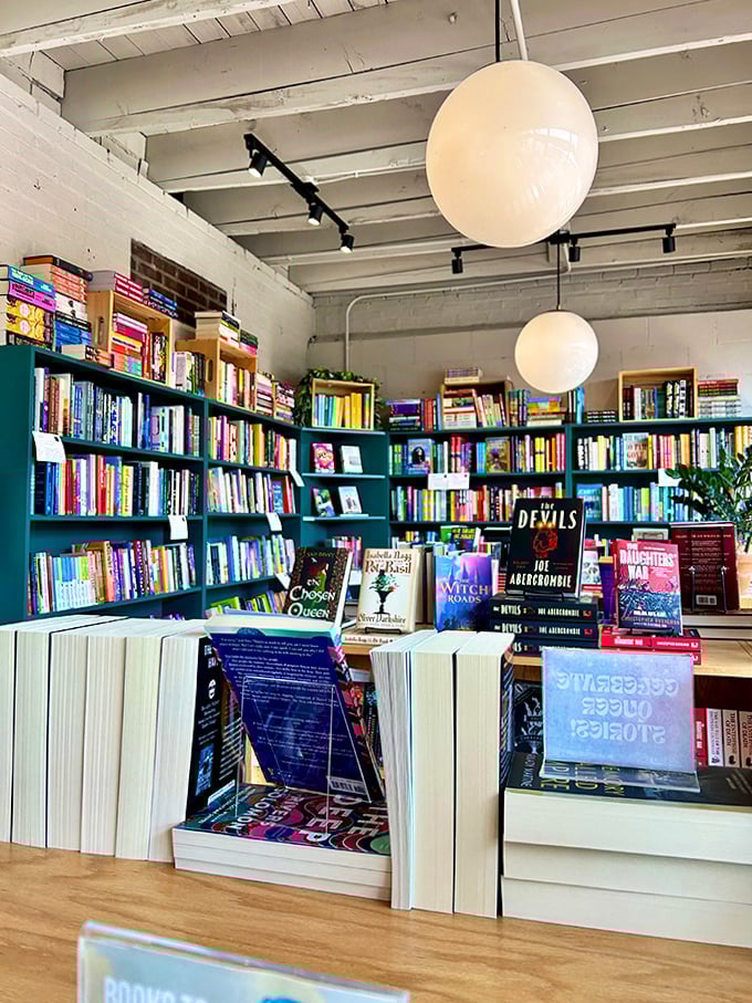 Spherical lights hover like literary moons, illuminating carefully curated displays that tempt even the most disciplined book budget.