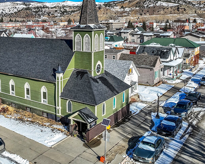 The green church steeple punctuates Anaconda's skyline, a spiritual landmark that's witnessed over a century of the town's triumphs and challenges.