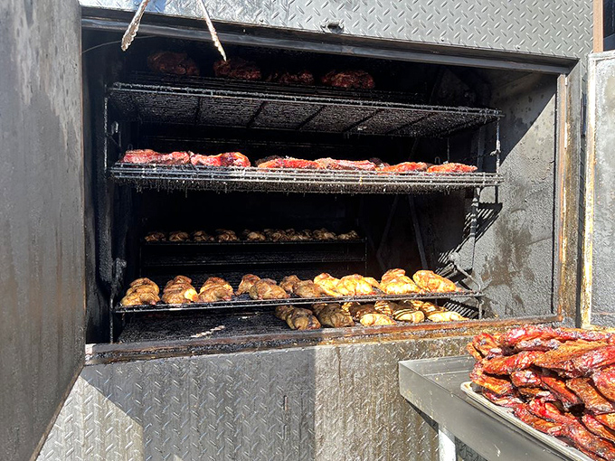 A peek inside the smoker reveals the magic happening&mdash;chicken and ribs getting the low-and-slow treatment they deserve.