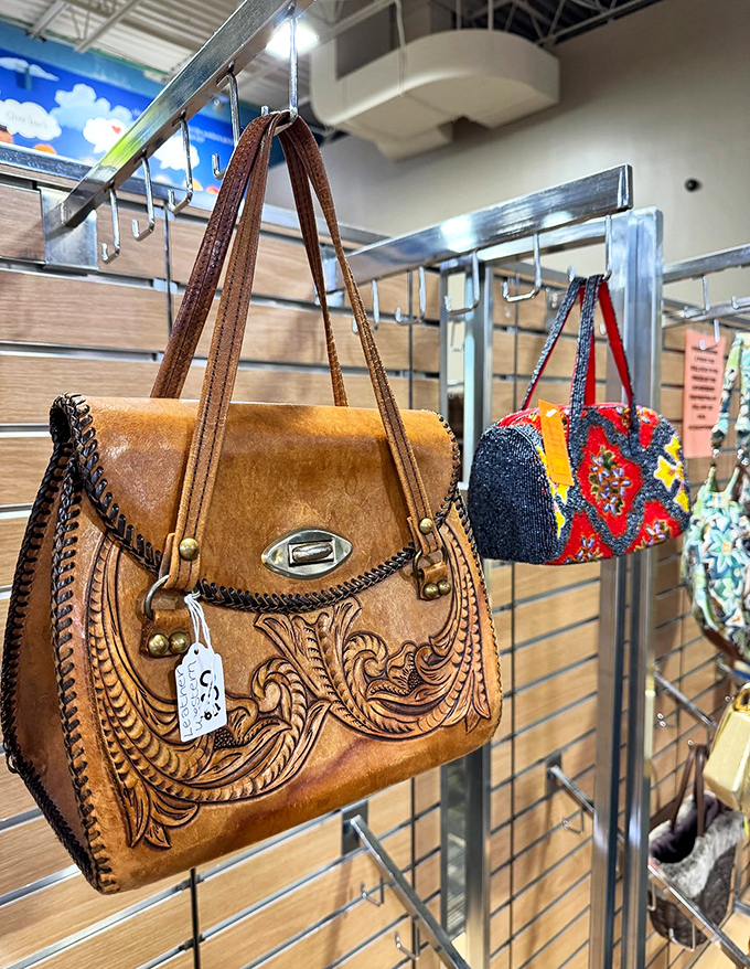 Handbag heaven! That tooled leather beauty with intricate scrollwork looks like it belongs on a fashionable ranch hand's arm.