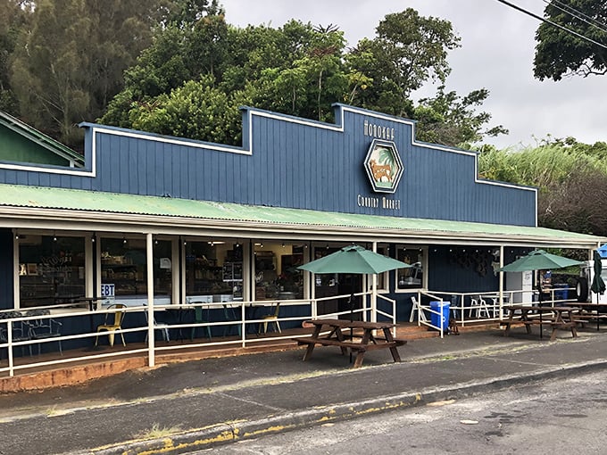 Honokaʻa Country Market's blue facade and welcoming patio invite you to linger over coffee and talk story with whoever happens by.
