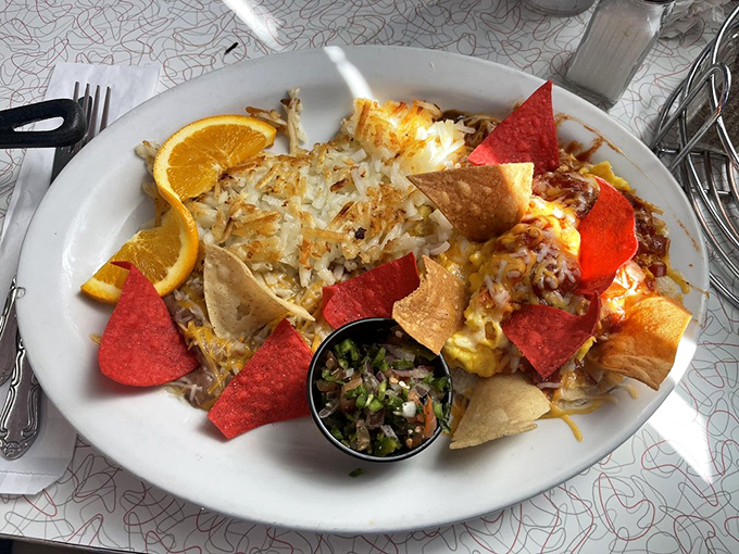 Huevos Rancheros reimagined with colorful tortilla chips creating a festive frame around eggs that look like they're ready for their close-up.