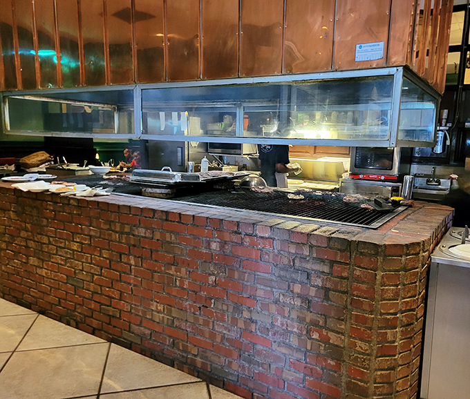 The heart of the operation: a brick-enclosed grilling station where magic happens over Tennessee hickory charcoal.