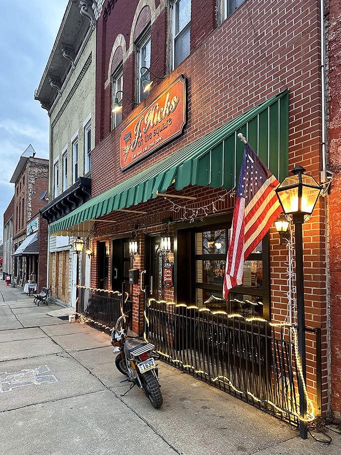 J. Hicks on the Square glows with evening charm, where the American flag waves and dinner conversations flow as smoothly as their drinks.