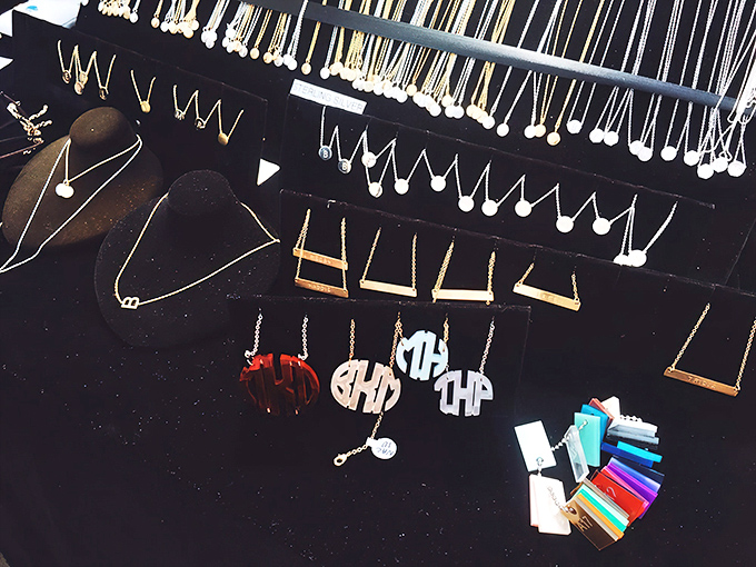 Monogram necklaces and delicate chains await new owners at this jewelry display, where personal style meets affordable luxury.