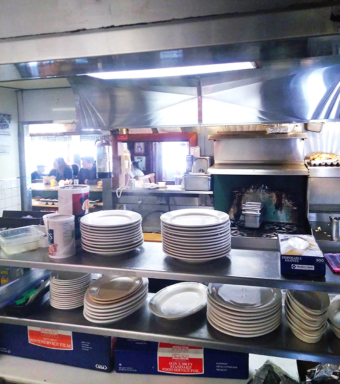 That open kitchen view with stacks of plates ready means serious breakfast volume is happening behind those grills.