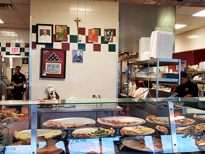 The open kitchen concept before it was trendy. Nothing builds trust like watching your pizza being made by people who clearly know what they're doing.