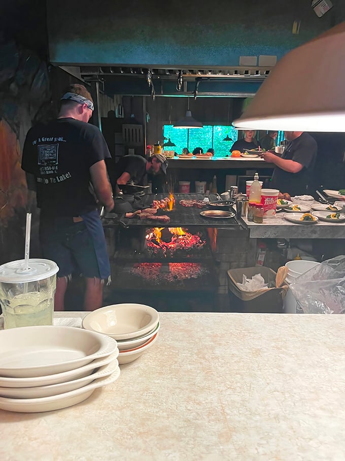 Where the magic happens – chefs tending to steaks over open flame, a timeless technique that no modern gadget can improve upon.