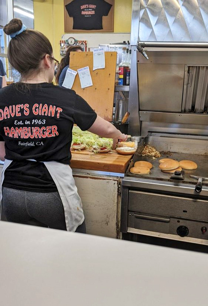 Behind the scenes where burger dreams come true. The staff moves with the confidence that comes from doing one thing exceptionally well for generations.