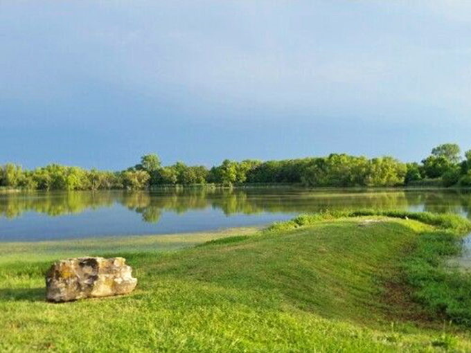 Nature's mirror: Lake Tanko offers serene waters reflecting Kansas skies, proving you don't need mountains for breathtaking landscapes.