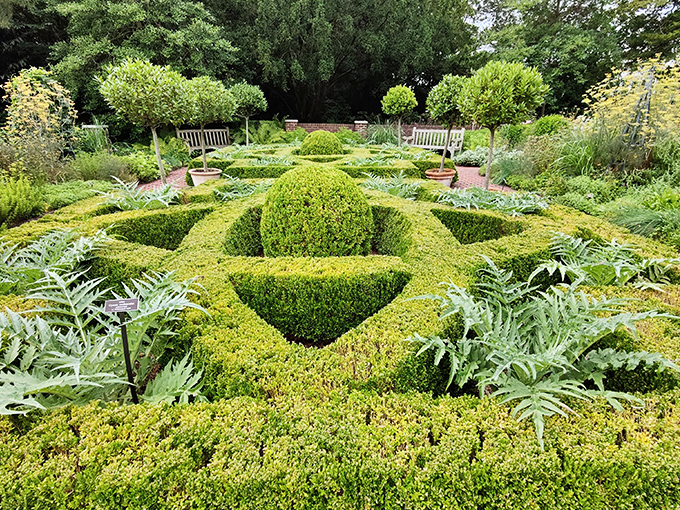 A formal garden with hedges trimmed with such precision that you suspect the gardeners might have previously worked as Swiss watchmakers.