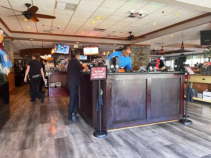 The host station—that magical gateway between hunger and satisfaction. Notice the warm wood tones and stone accents that set the stage for comfort food bliss.