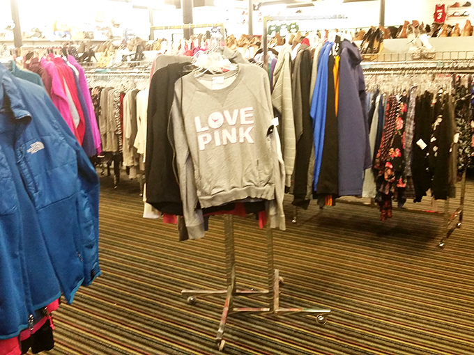 The "LOVE PINK" sweatshirt stands sentinel among racks of potential. Someone's impulse buy becomes your wardrobe staple.
