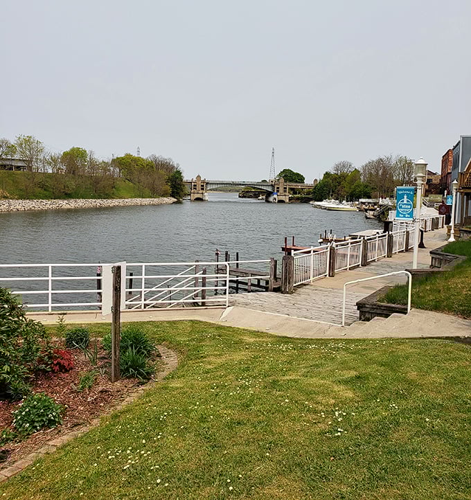 Manistee's Riverwalk offers front-row seats to the gentle dance between river and lake, with the town's historic bridge as backdrop.
