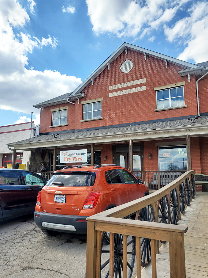 The red brick Mercantile building stands ready for business, its elevated wooden walkway adding character that modern strip malls spent millions trying unsuccessfully to replicate with fake weathering techniques.