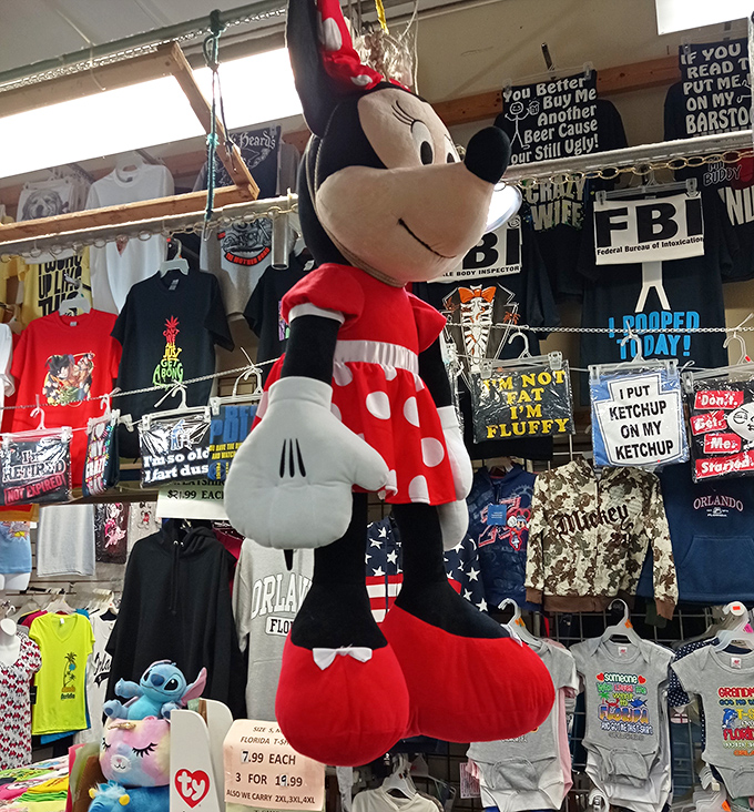 Minnie Mouse watches over a kingdom of plush characters, silently judging those who pass by without stopping to admire her polka dots.