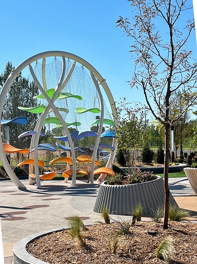 This whimsical outdoor art installation provides a perfect spot for weary shoppers to rest while their credit cards cool down.