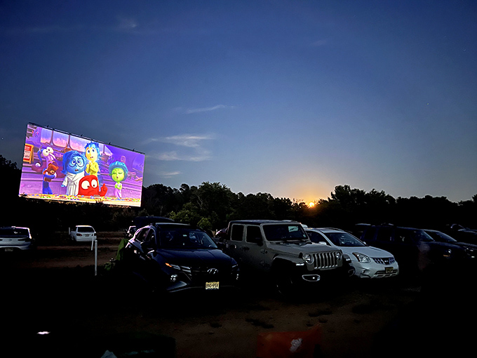 Animation comes alive against the darkening sky. The juxtaposition of modern films in this vintage setting creates a uniquely timeless experience.