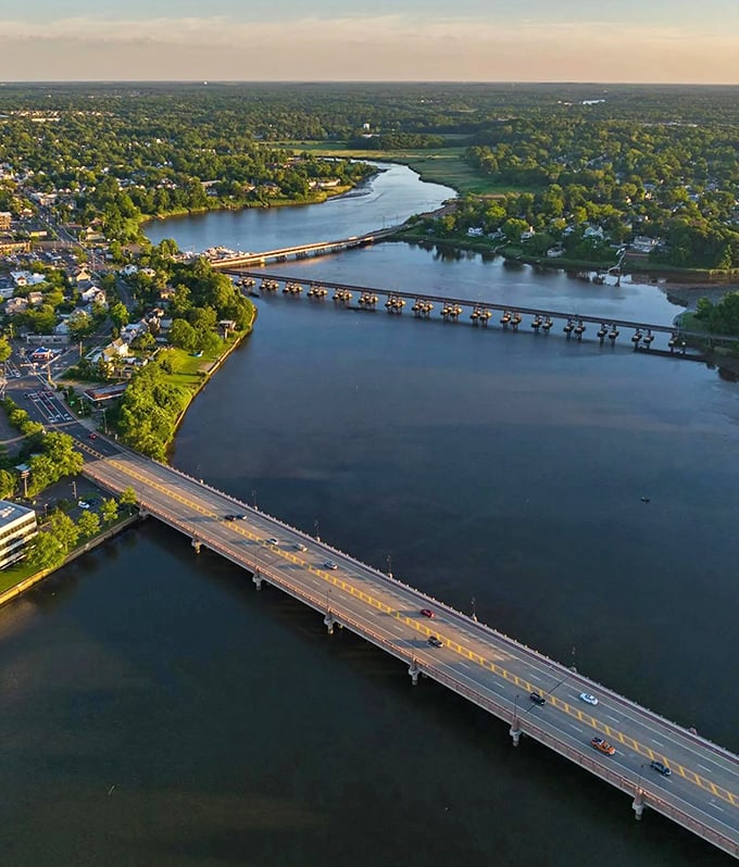 The Navesink River unfurls like a blue ribbon through the landscape, connecting Red Bank to the wider world while reflecting perfect postcard skies.