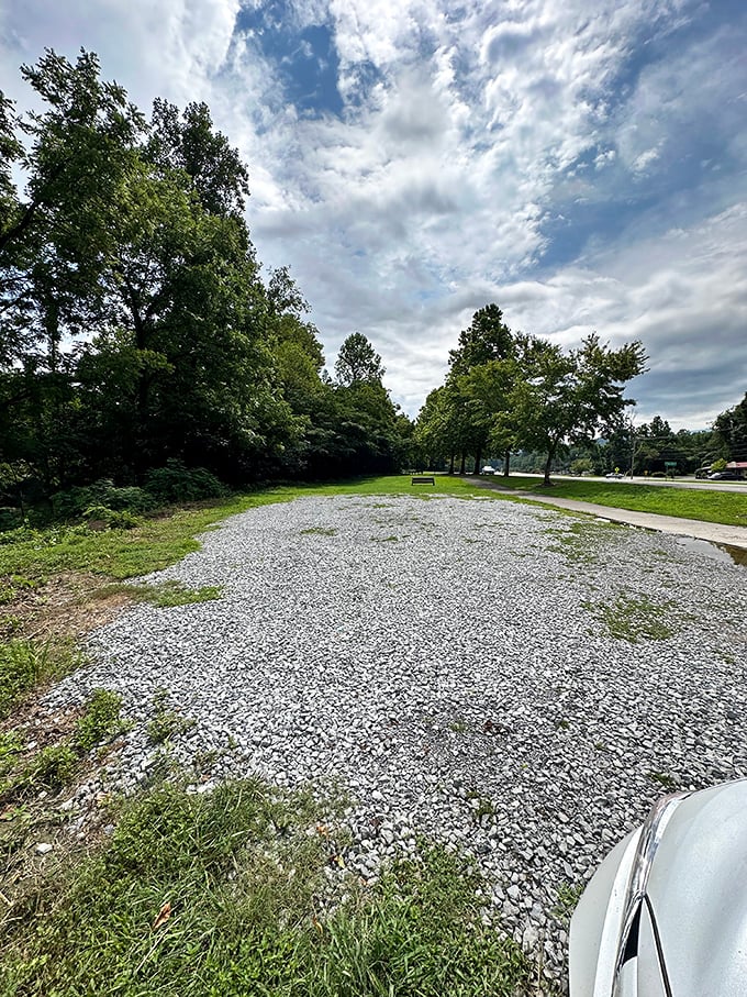 The unassuming gravel approach doesn't prepare you for what's ahead—like a modest doorway that opens to an unexpected architectural treasure.