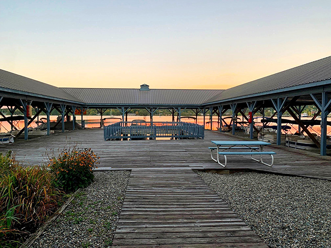 Newport's covered marina offers boats the equivalent of a cozy sweater. That sunset glow transforms ordinary wood into something magical.